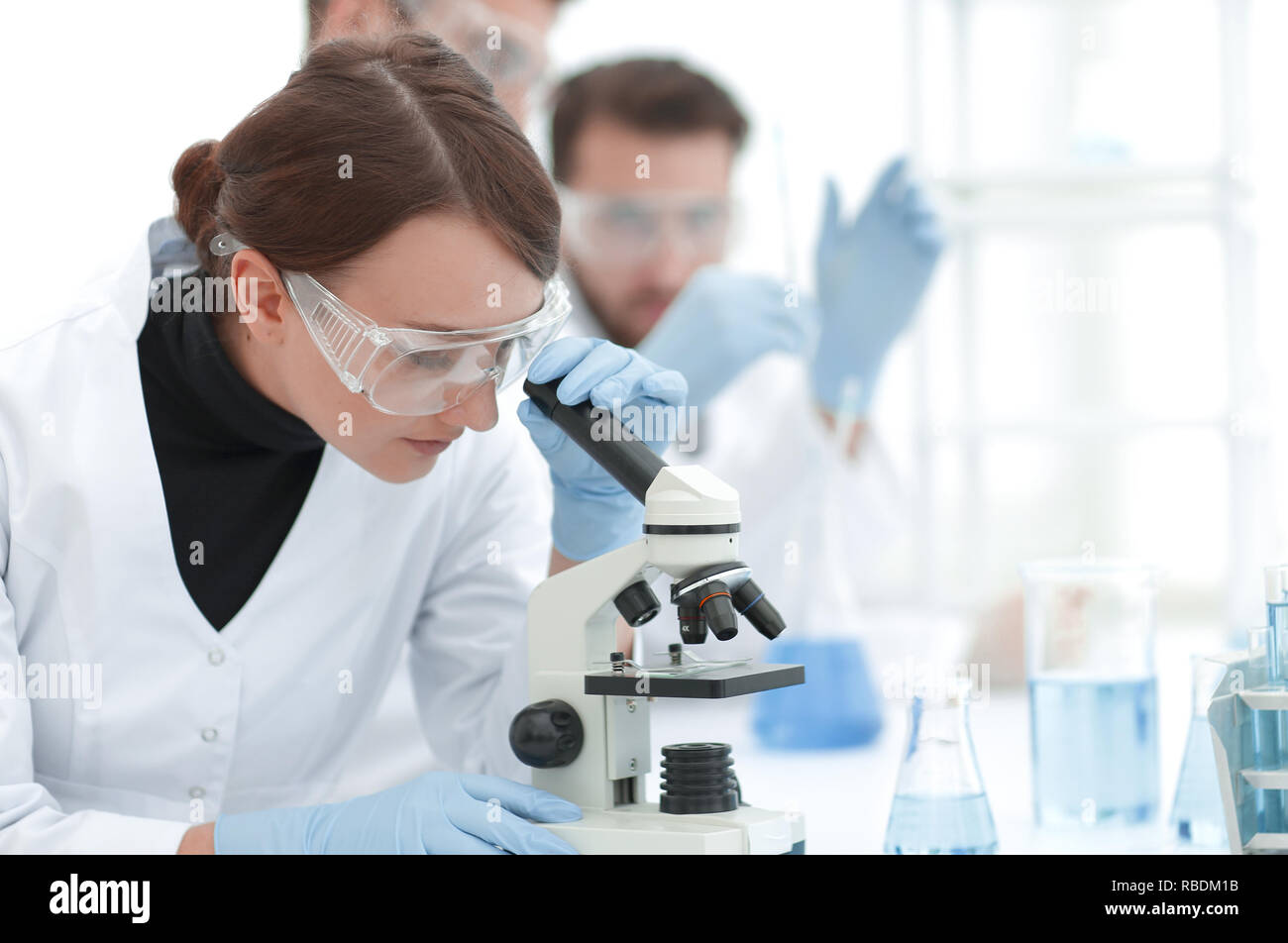 female scientists looking into a microscope Stock Photo - Alamy