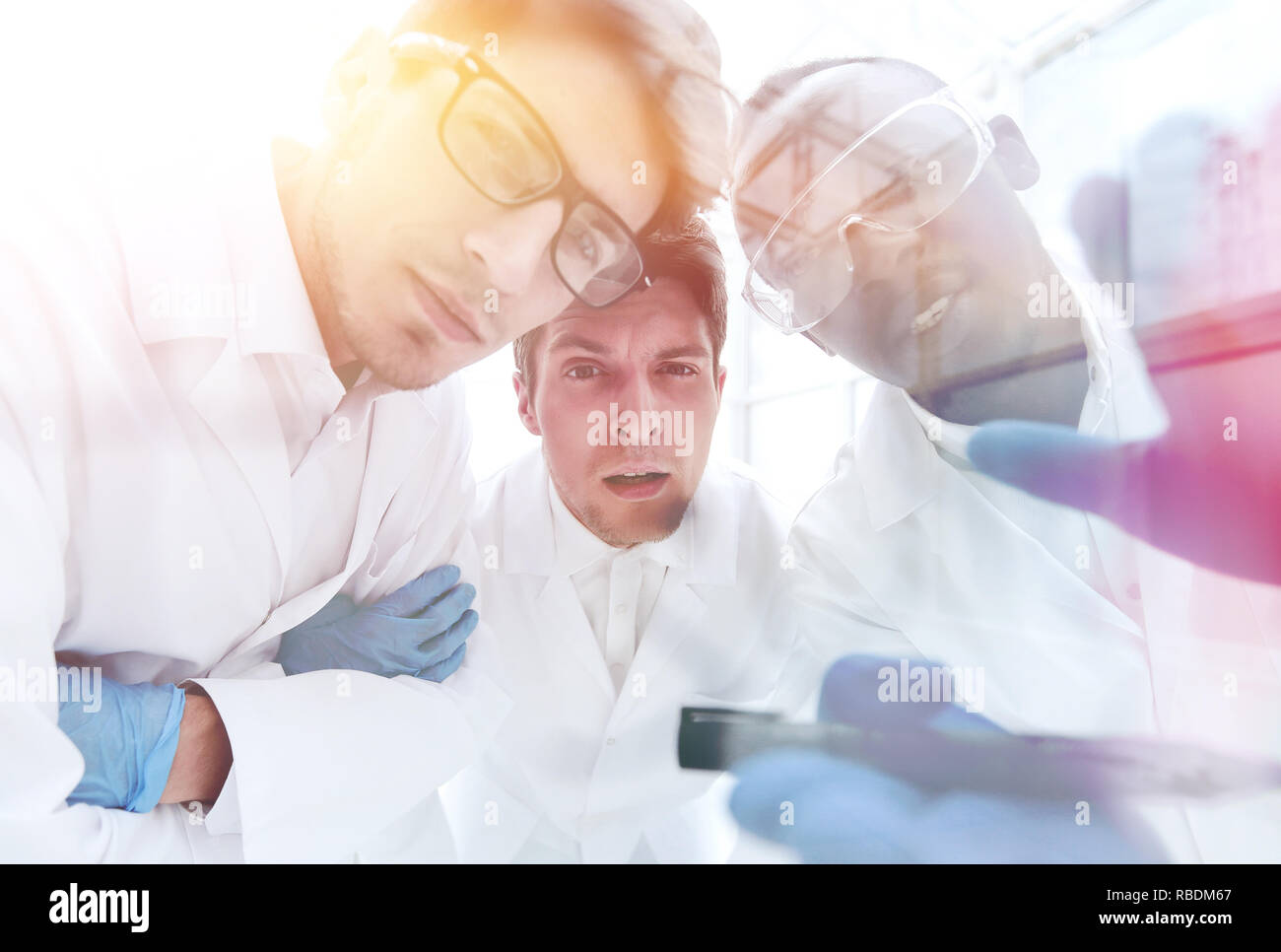 close up.a group of scientists discussing the results of the experiment ...