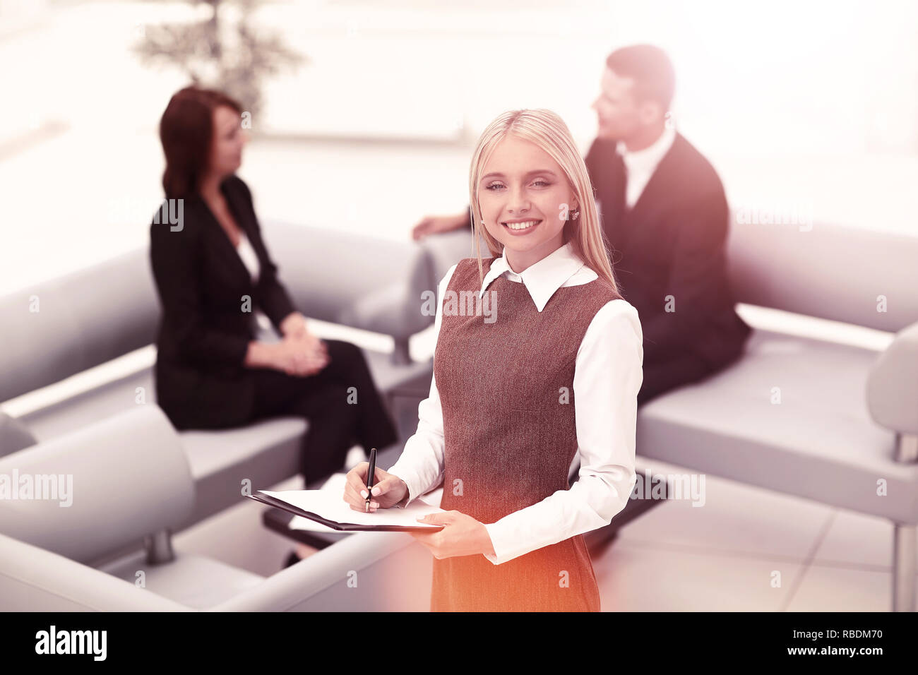 woman assistant standing in the lobby of the modern office .photo with ...