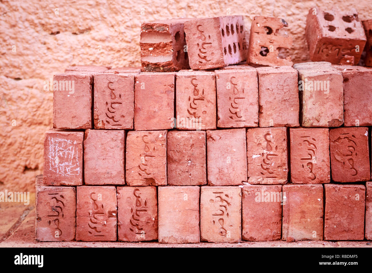 stack of red bricks with inscriptions on the street of Egypt on a Sunny ...