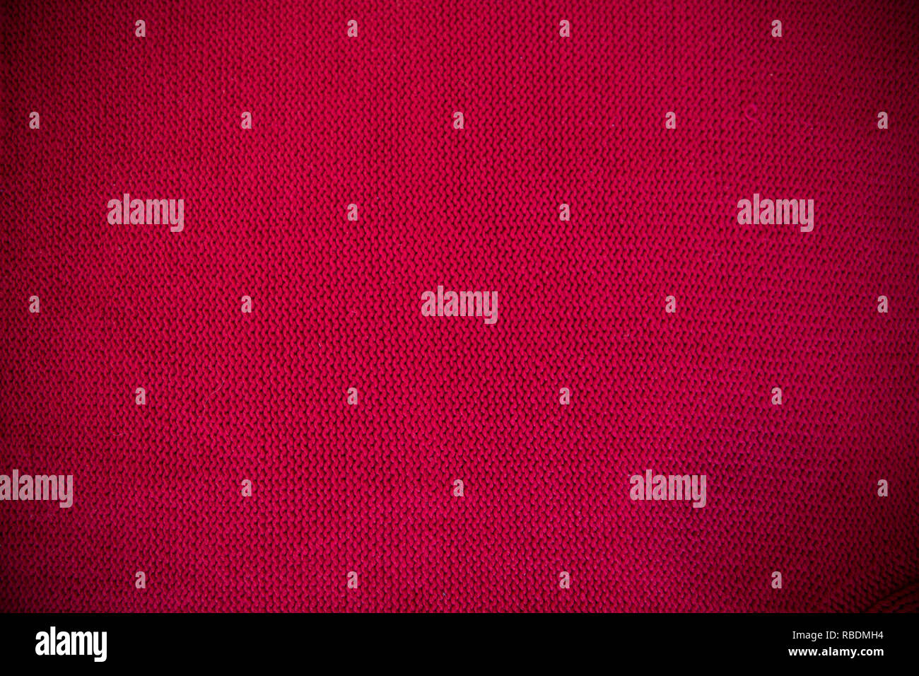Red Knitted pattern wool sweater texture close up. Handmade red ...