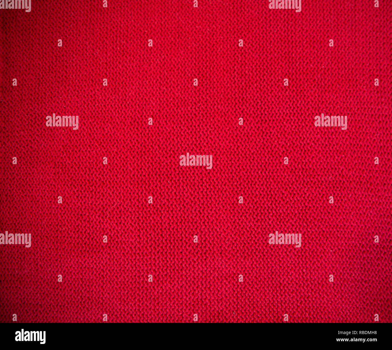 Red Knitted pattern wool sweater texture close up. Handmade red ...