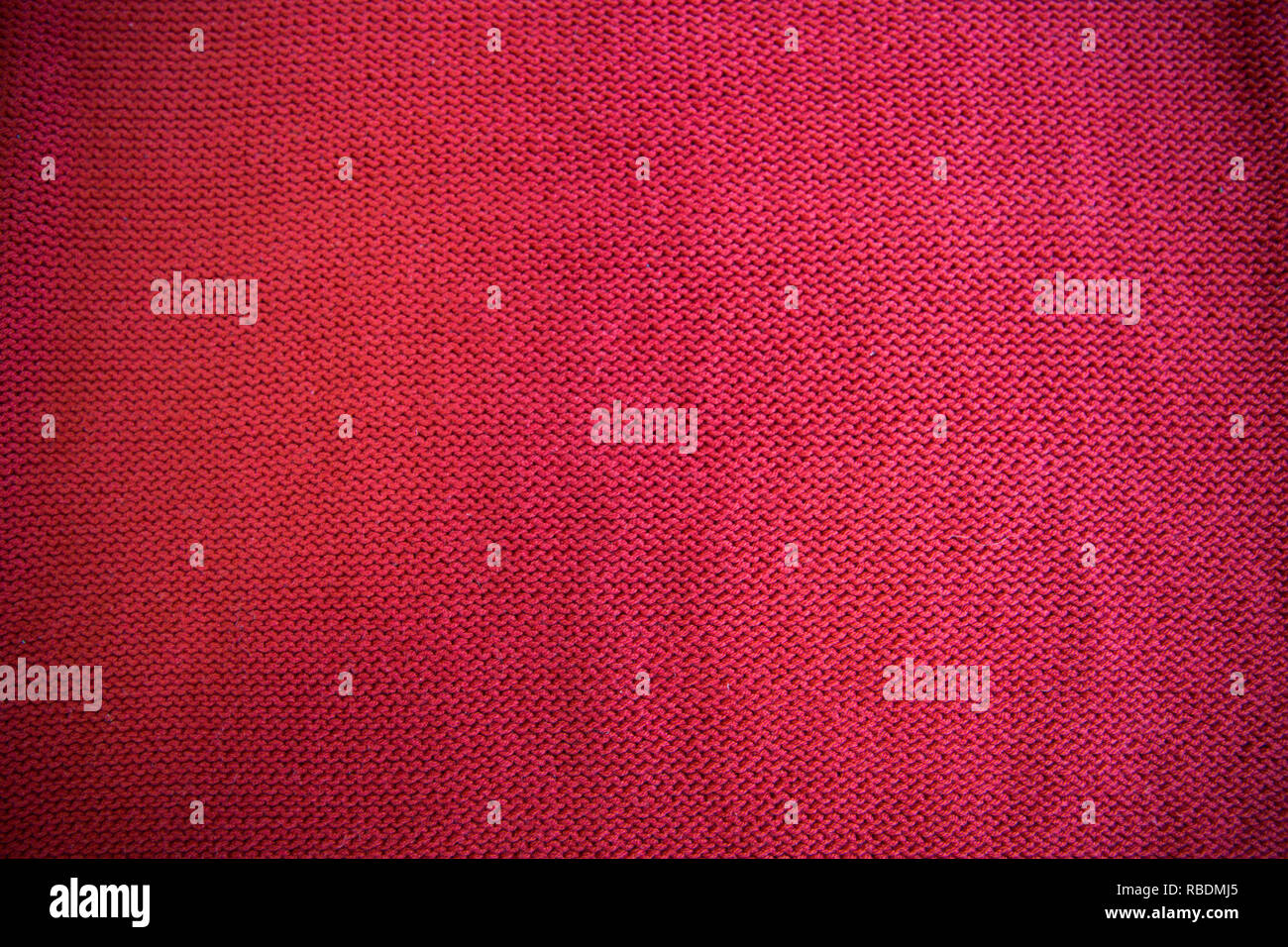 Red Knitted pattern wool sweater texture close up. Handmade red ...