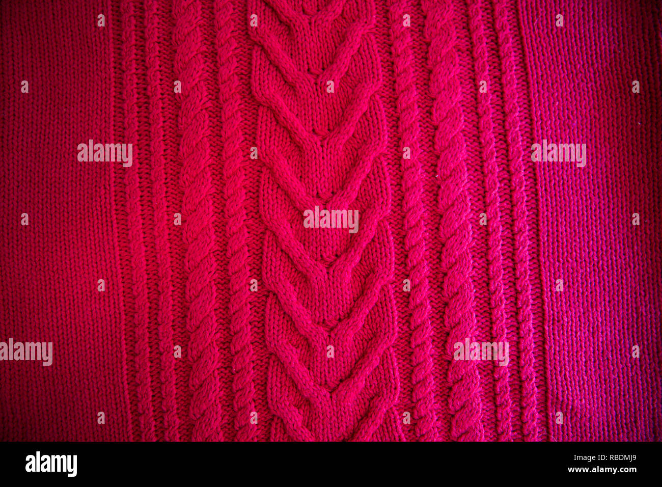 Red Knitted pattern wool sweater texture close up. Handmade red ...