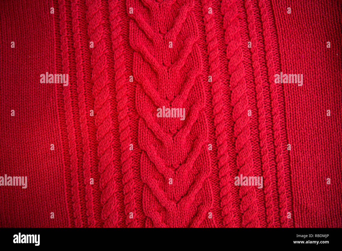 Red Knitted pattern wool sweater texture close up. Handmade red ...