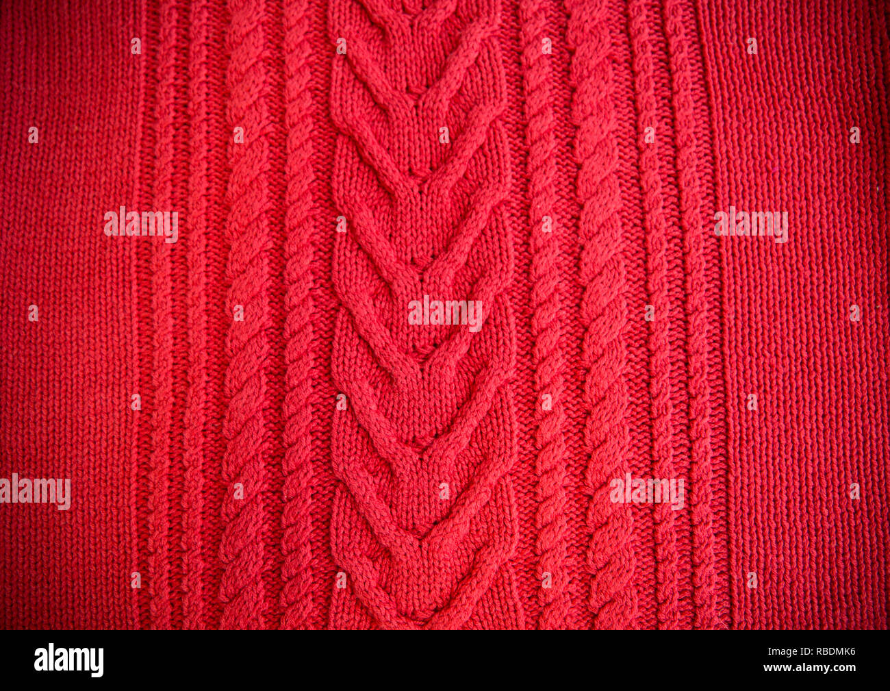 Red Knitted pattern wool sweater texture close up. Handmade red ...