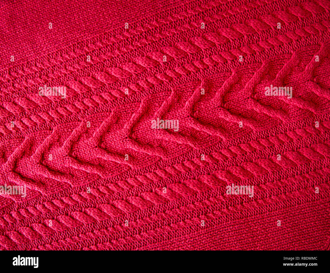 Red Knitted pattern wool sweater texture close up. Handmade red ...