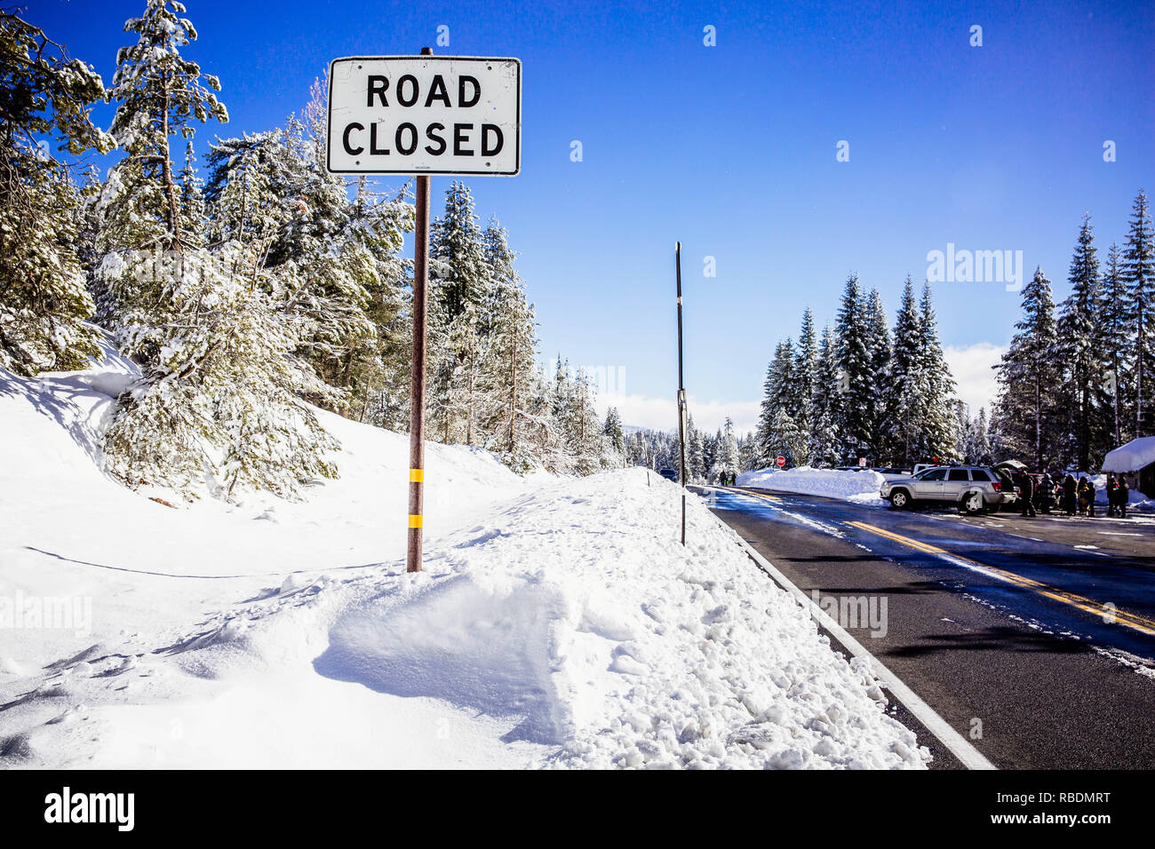 Road closed sign in snowy road in a winter forest. Icy country road in ...