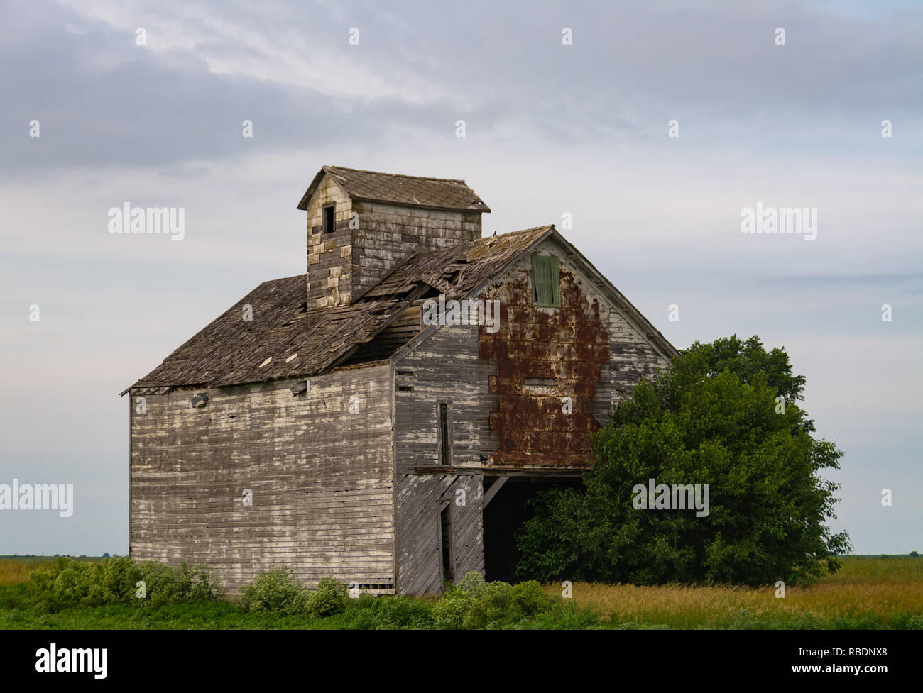 Old wooden barn in rural Central Illinois as the rain clouds start to ...