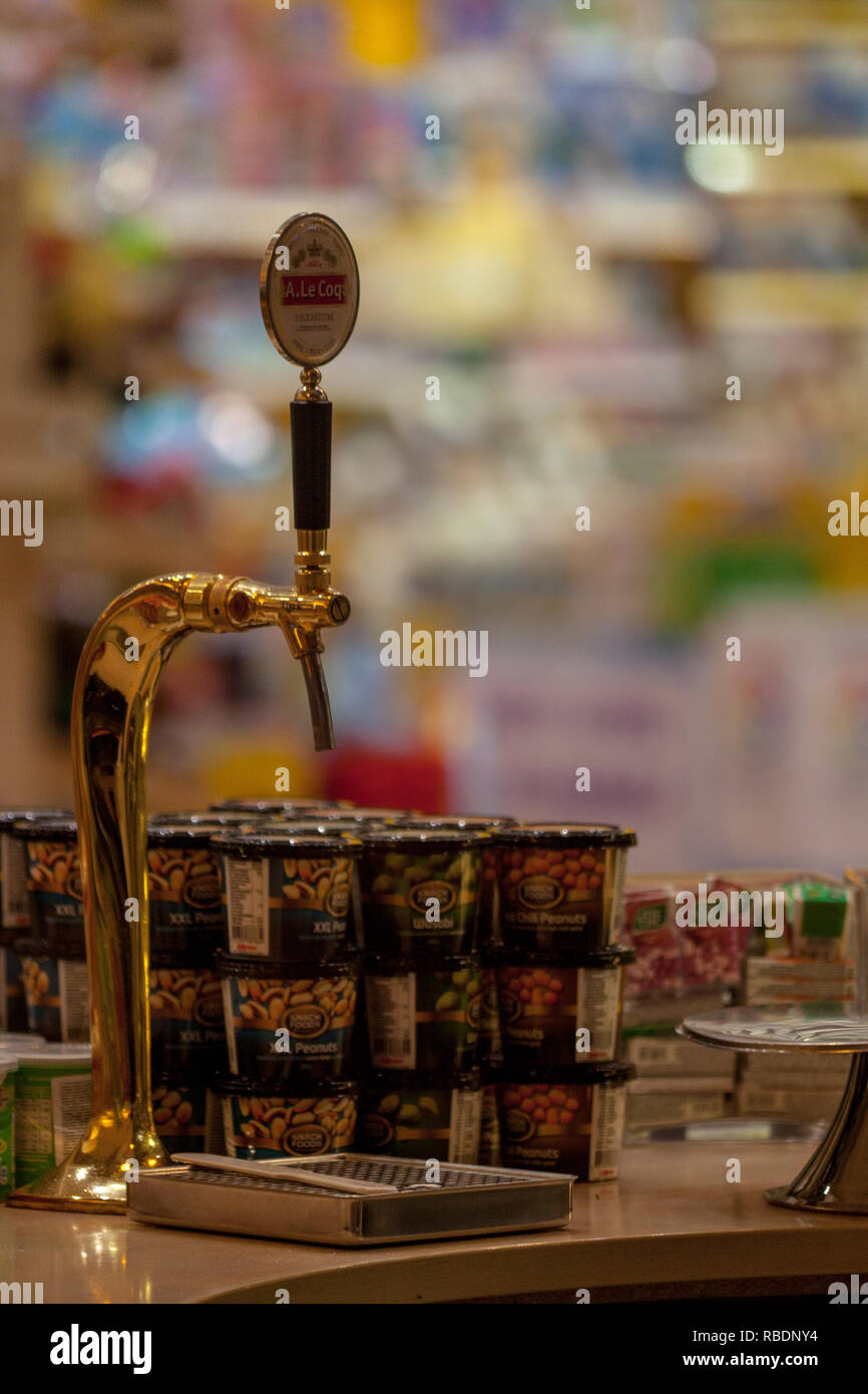 A beer tap in a bar on a colourful background Stock Photo - Alamy