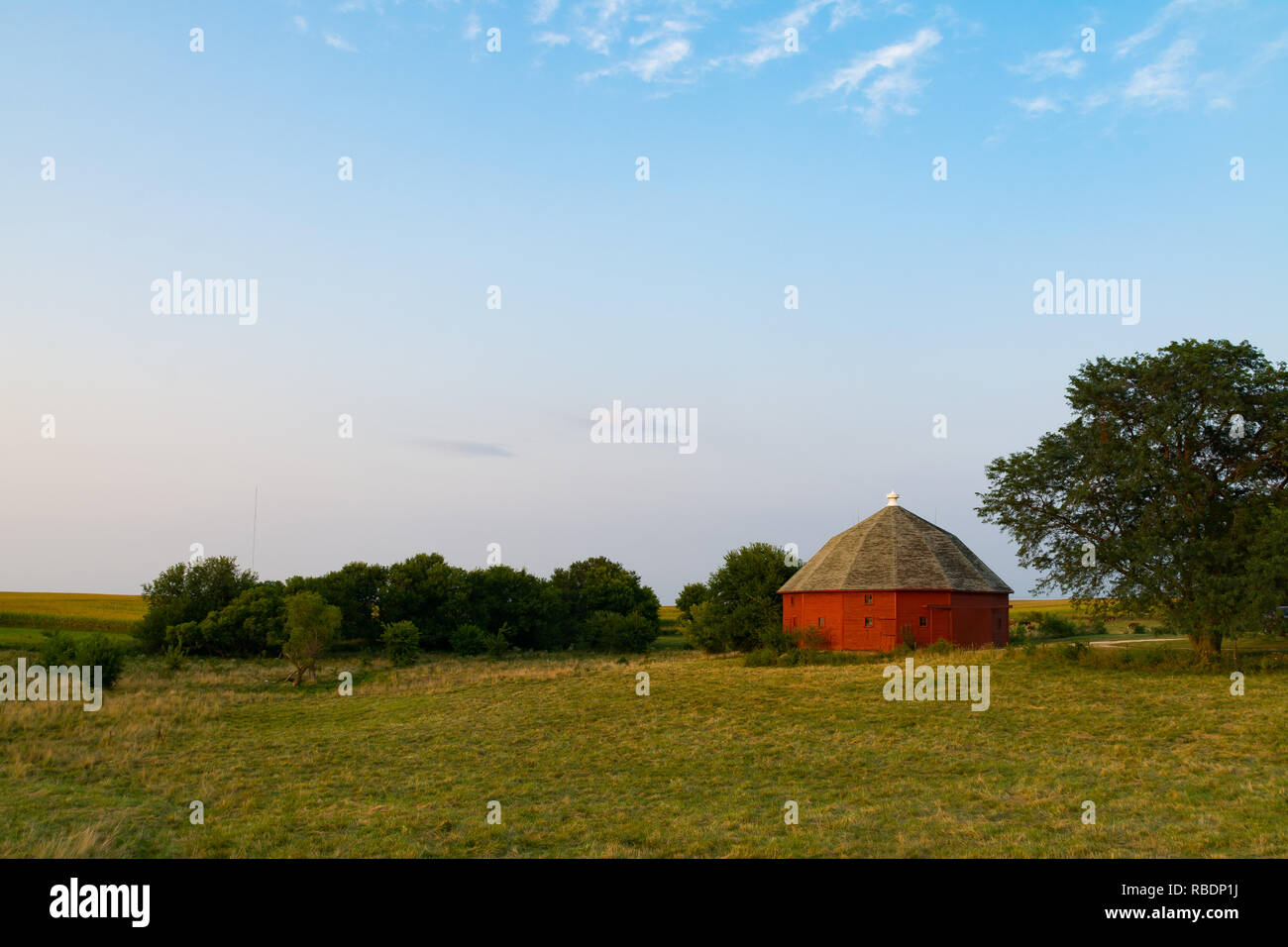 Red round barn in the open field in the late afternoon light. LaSalle ...