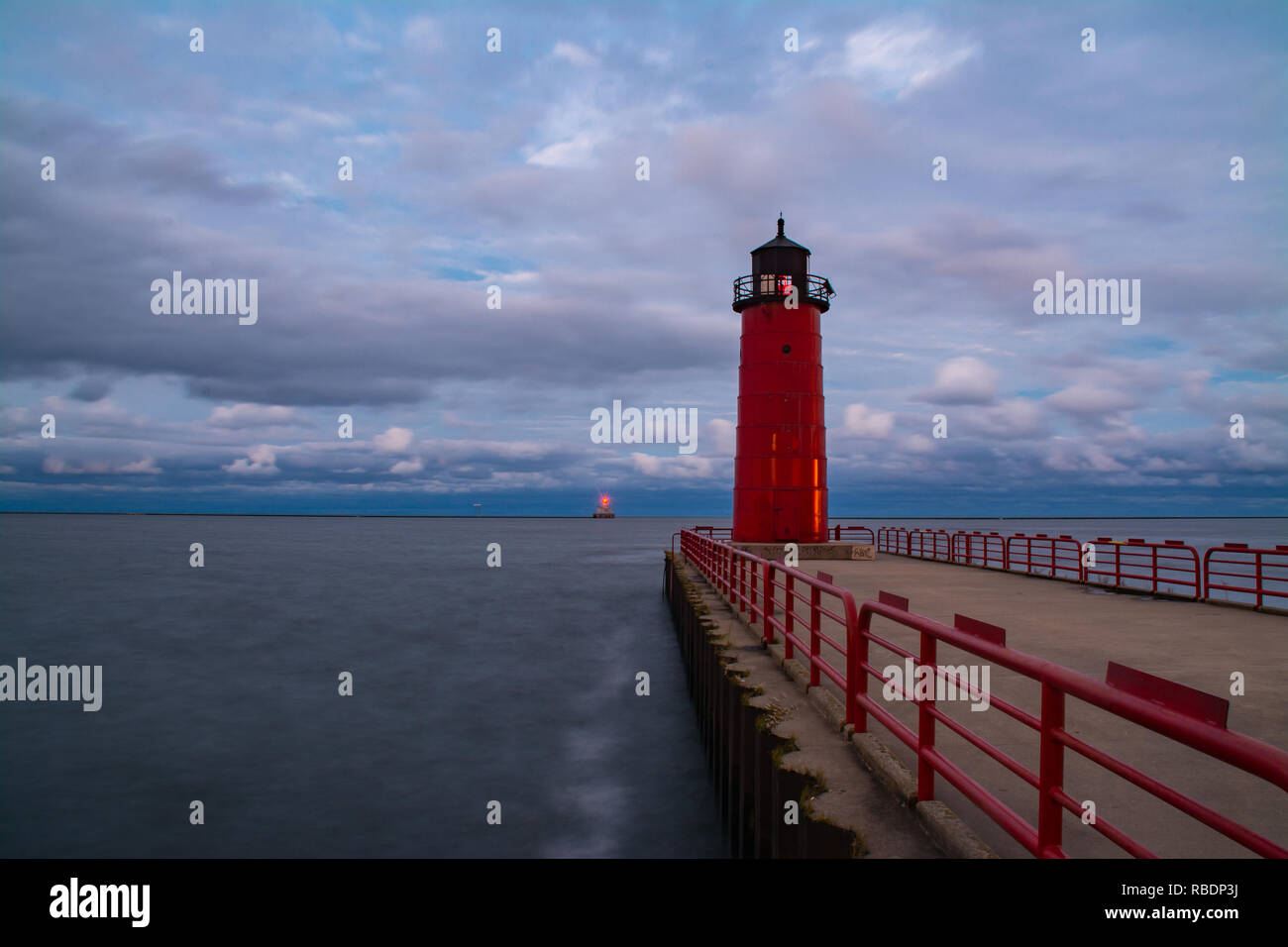 The "Milwaukee Pier Head Lighthouse" as the sun sets and the rain ...