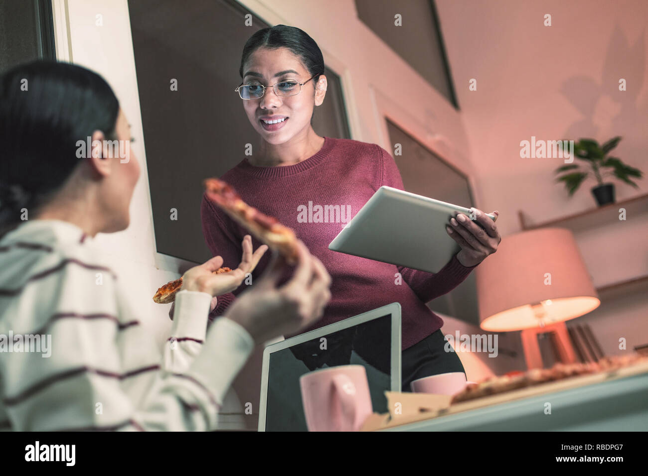 Rest after work. Charming manager sitting at her workplace and having ...