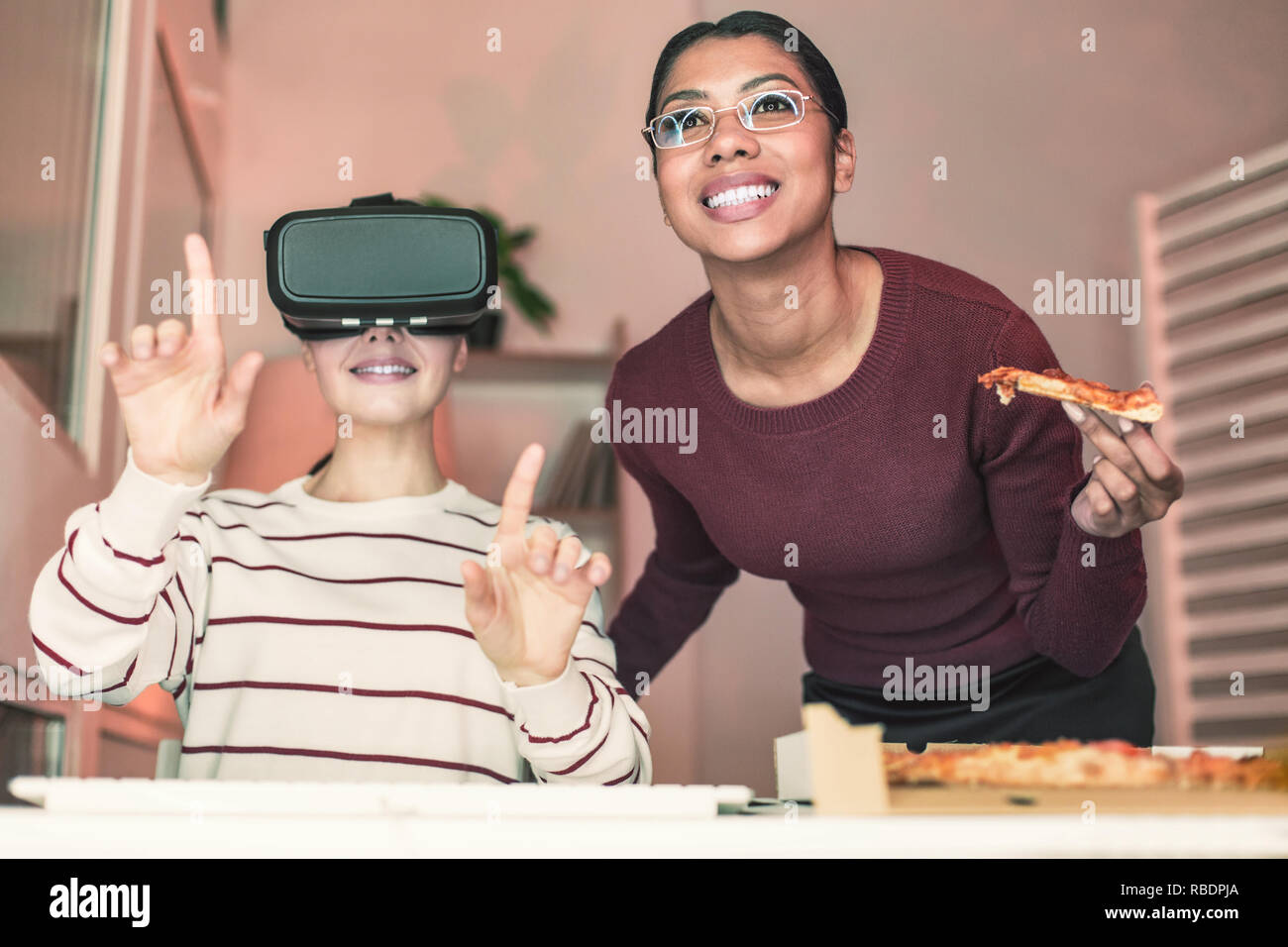 Waiting for result. Joyful girl wearing smart glasses while testing ...