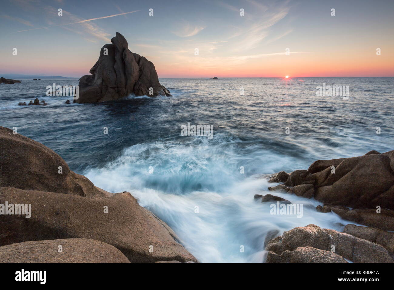 Sunset on modeled cliffs by wind framing blue sea Capo Testa Santa ...