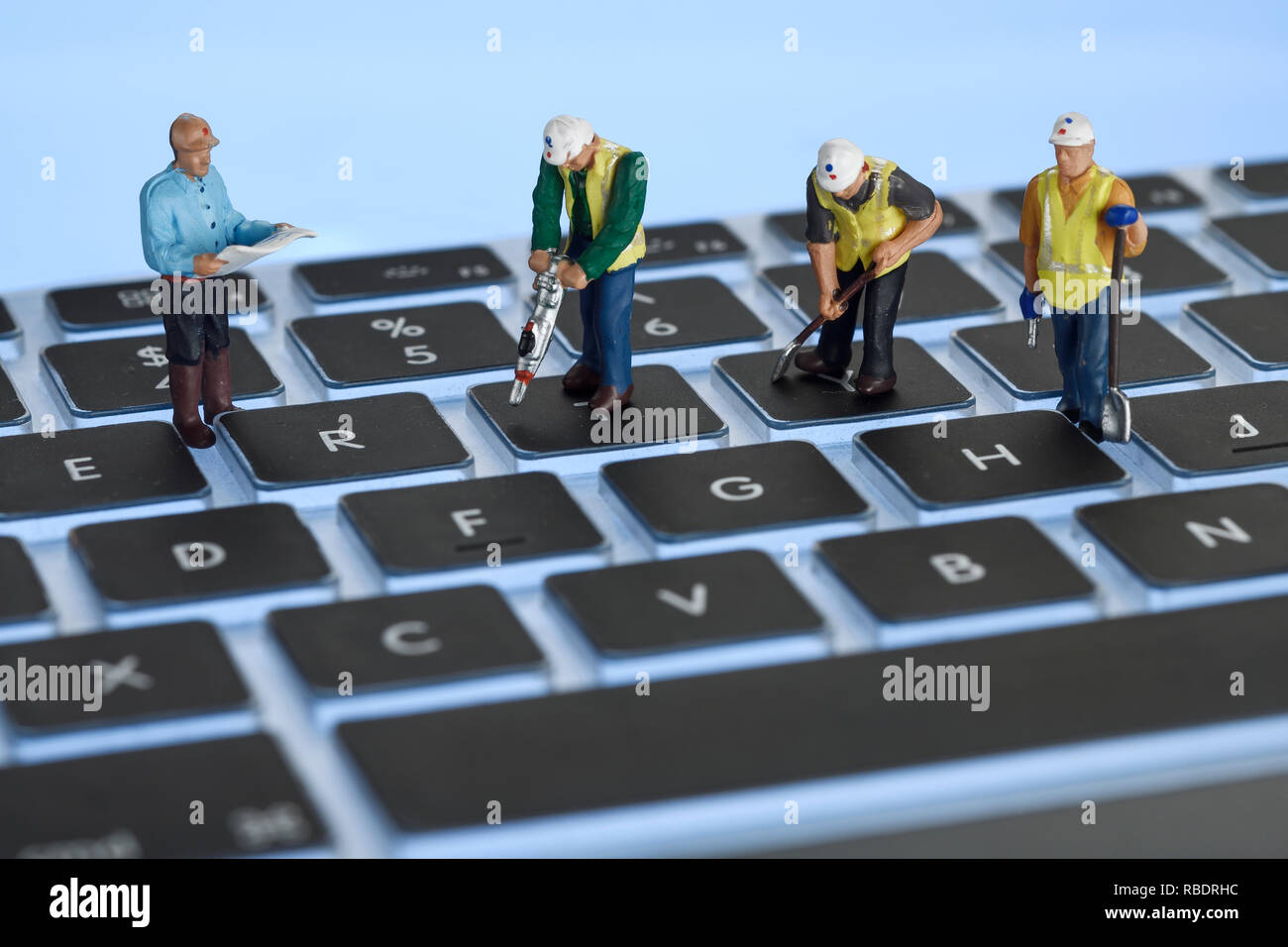 A computer keyboard with some workmen Stock Photo - Alamy