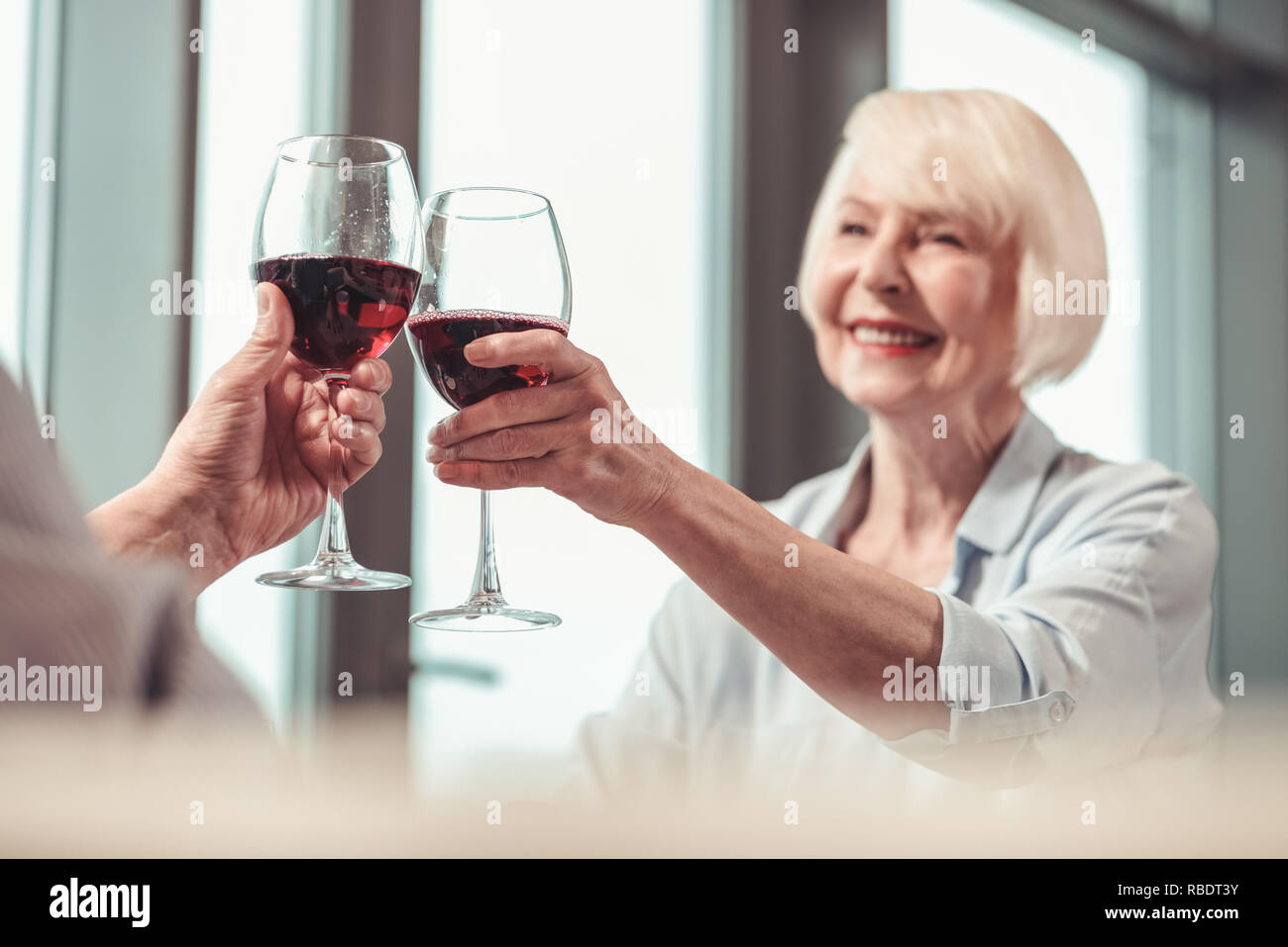 Great moments. Pretty lady drinking red wine while sitting in a ...