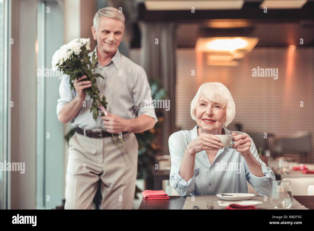 Pleasant meeting. Happy retired lady feeling good while waiting for a ...