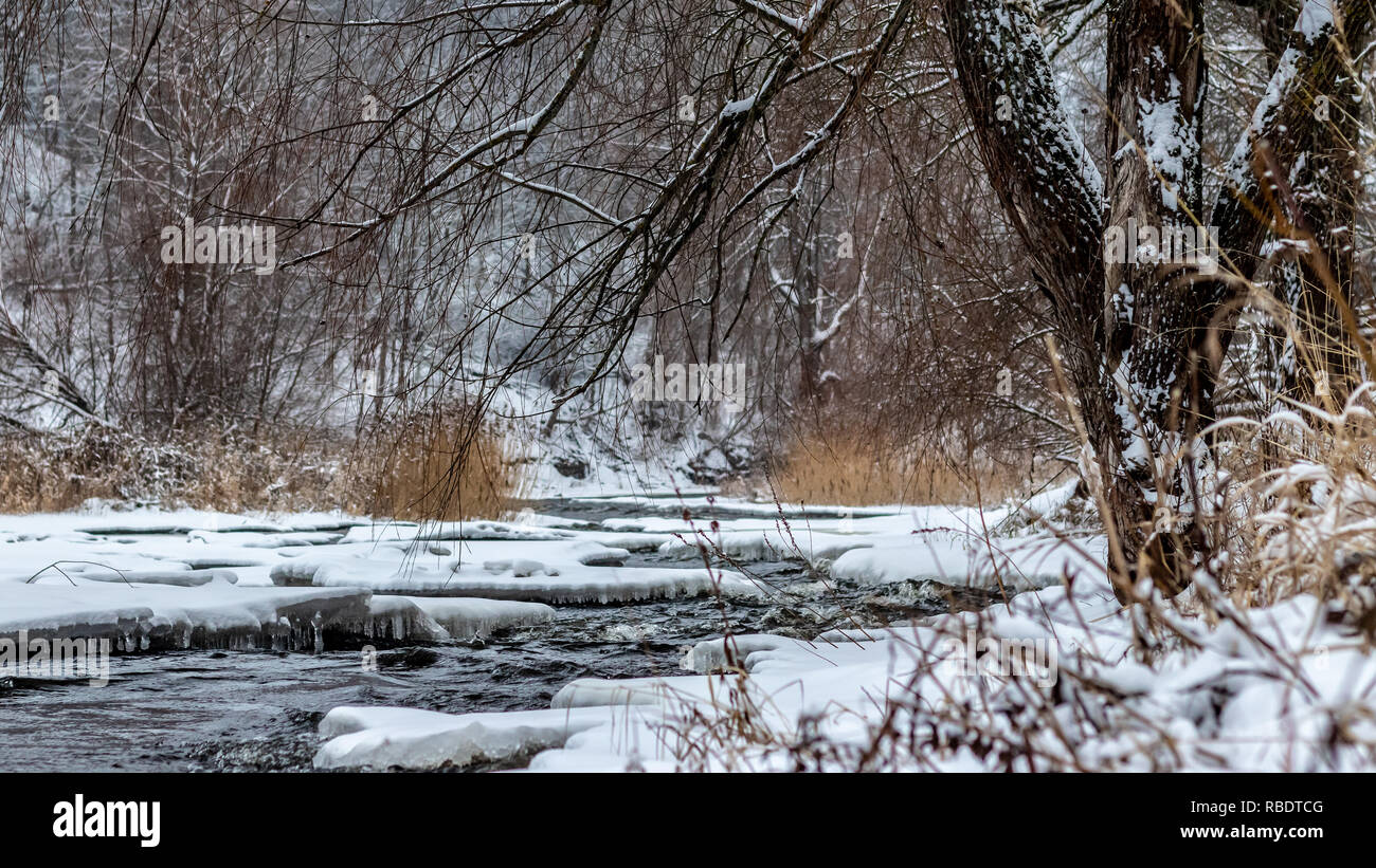 Running river water under frozen hi-res stock photography and images ...