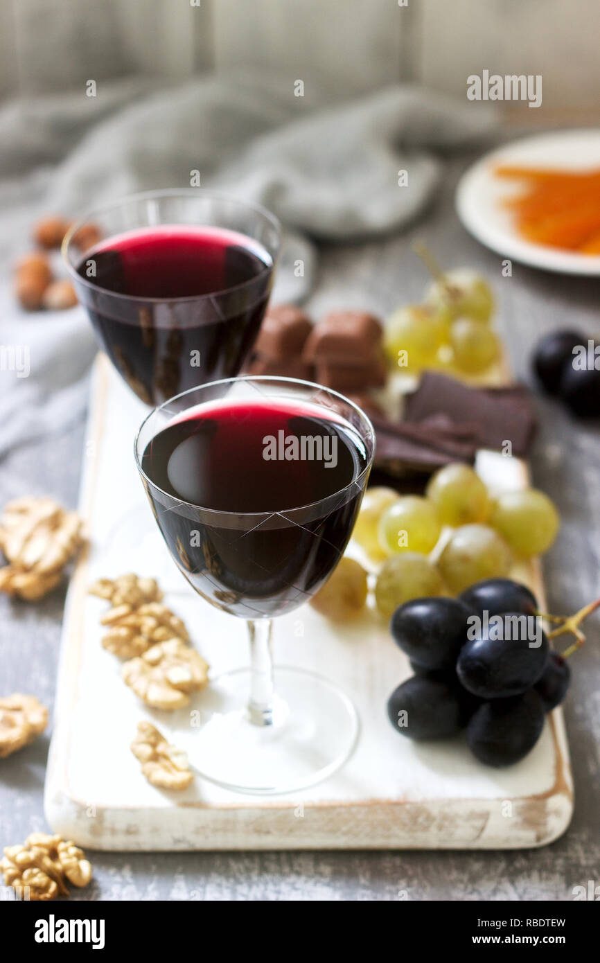 Creme de Cassis homemade liqueur served with grapes, nuts and chocolate ...