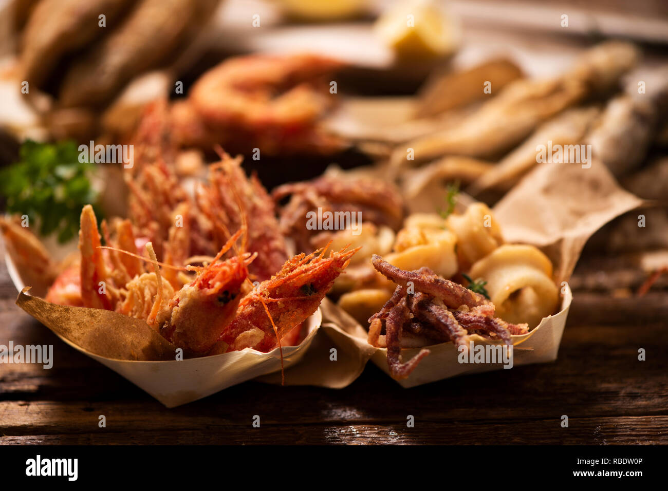 Fish fried fish on a tbale in the street food stand Market. Close up ...