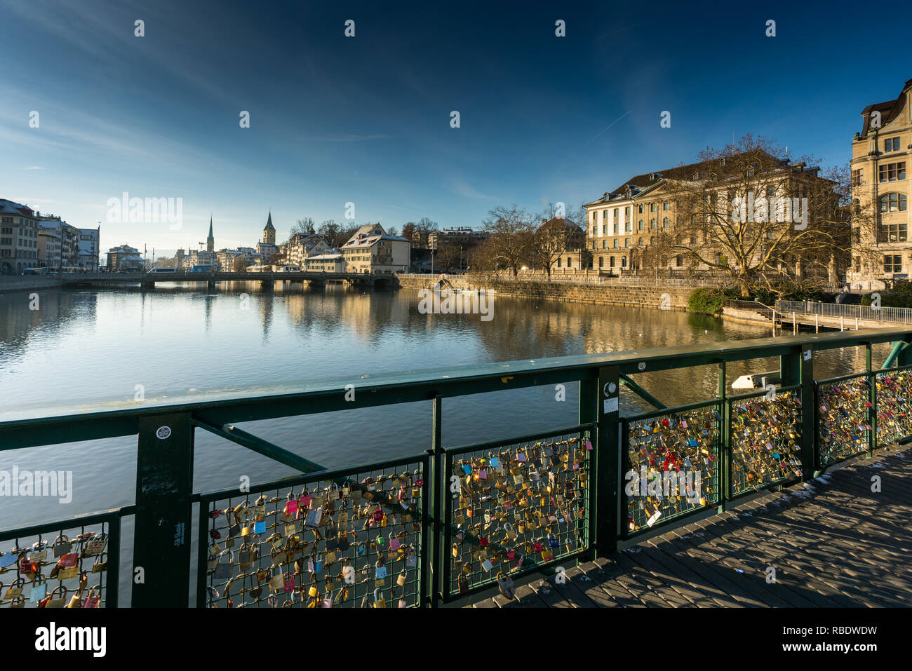 many different color and style locks and the wire railing of a bridge ...