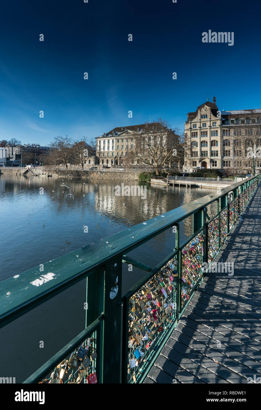 many different color and style locks and the wire railing of a bridge ...