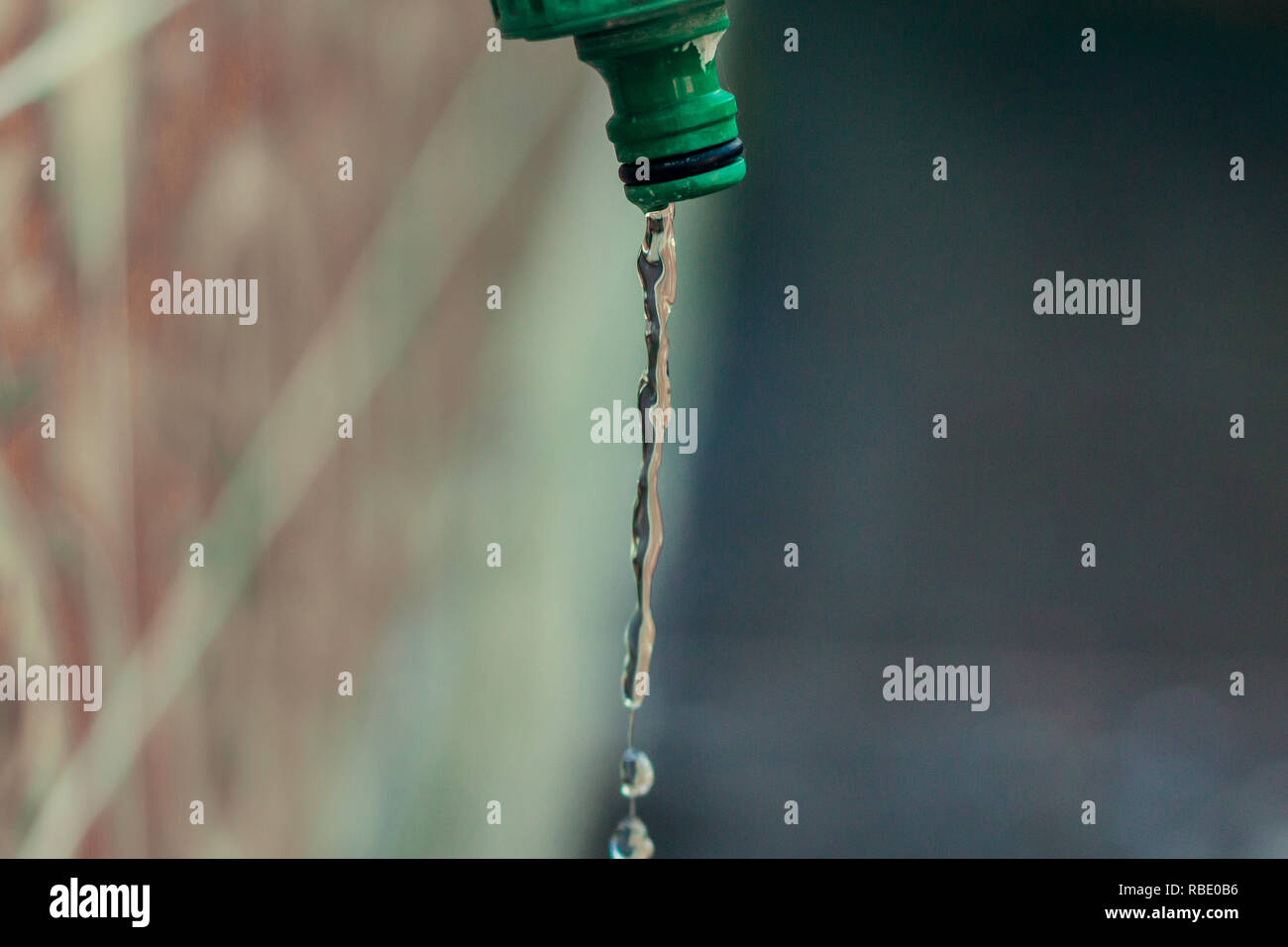 Water dripping from a faucet in the yard Stock Photo - Alamy