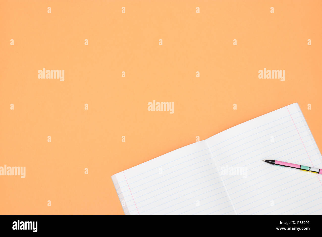Notebook, pen and colored numbers on orange background. Accessories for ...