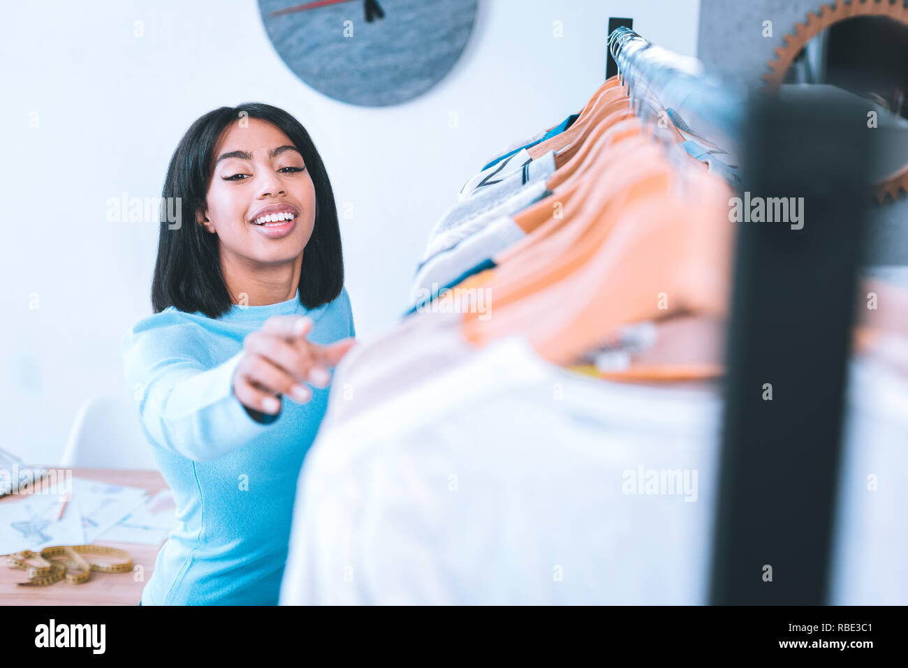 Give me this. Pretty indian woman smiling buying new clothes at her ...