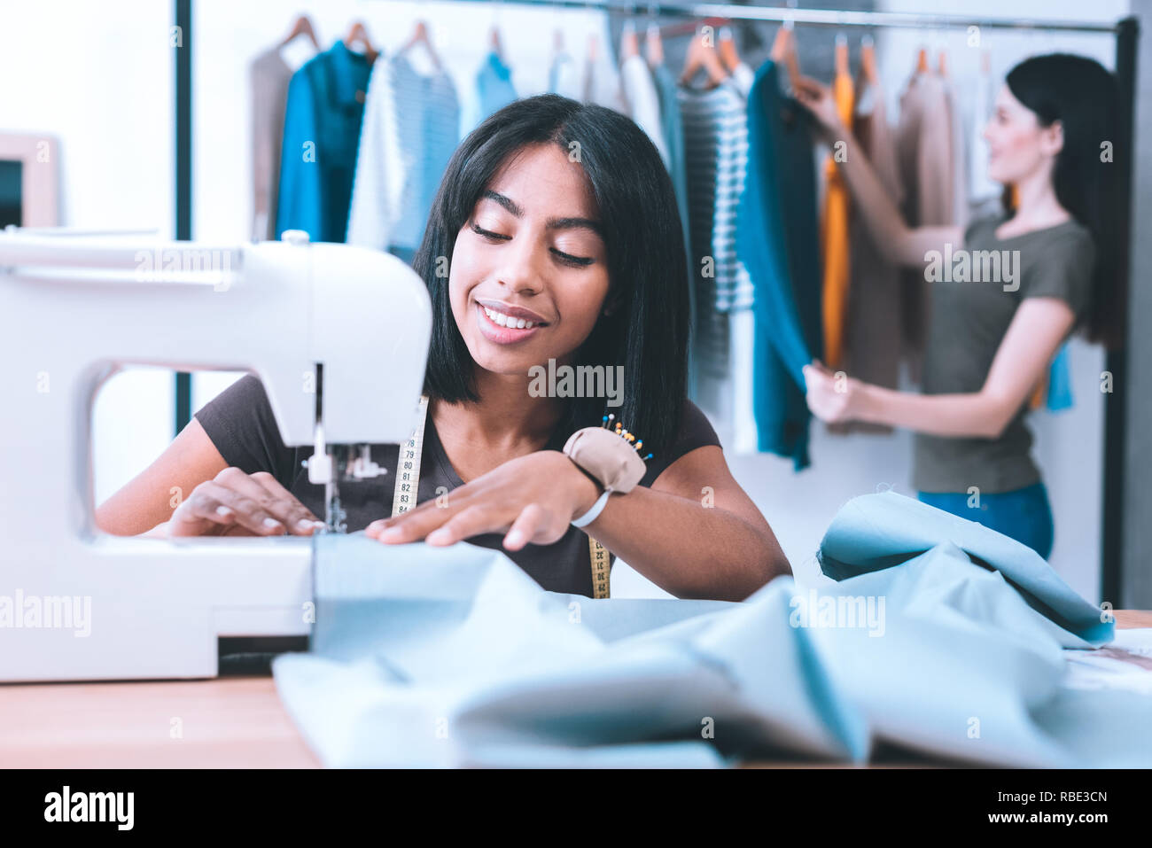 Interesting lesson. Young student learning how to using sewing machine ...