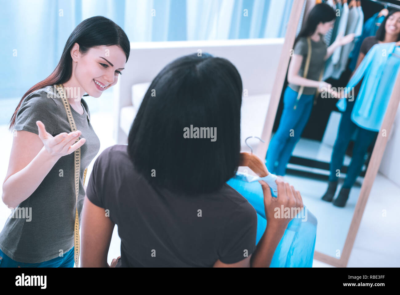 That is perfect. Nice pretty shop assistant helping customer choosing a ...