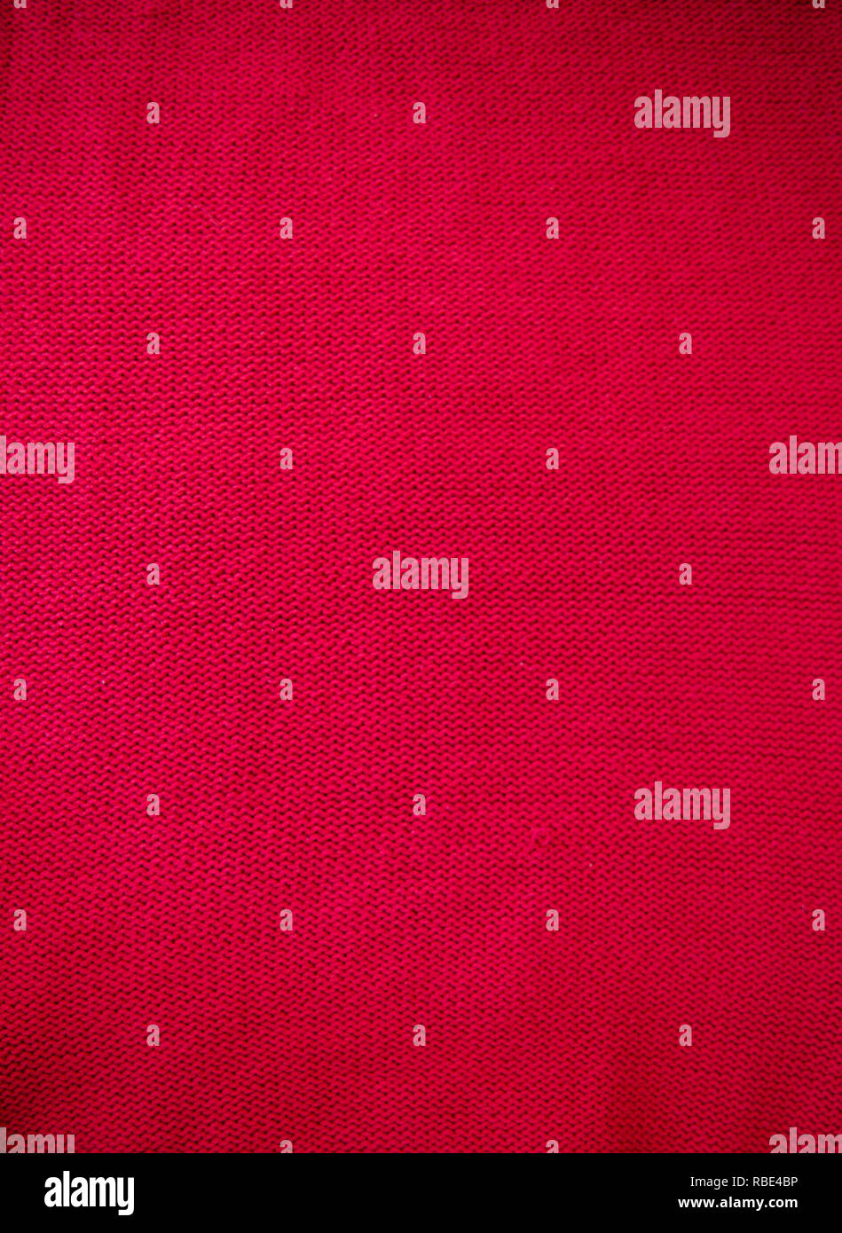 Red Knitted pattern wool sweater texture close up. Handmade red ...