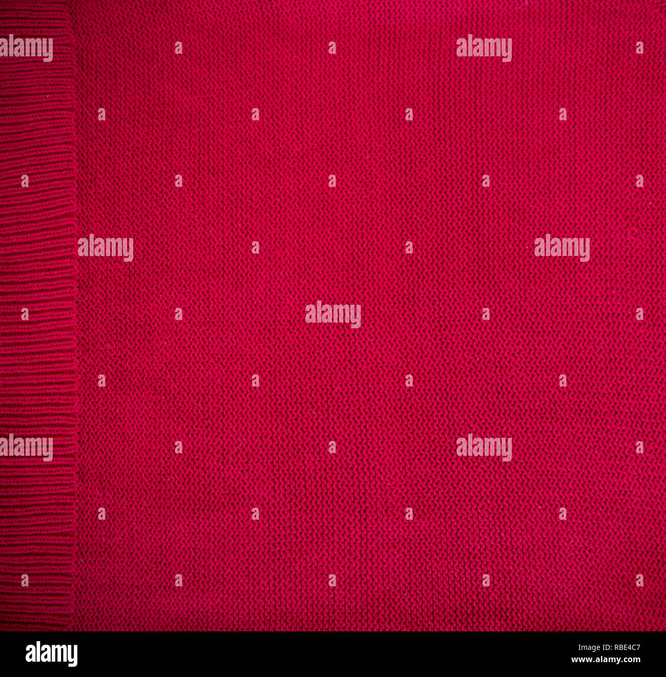 Red Knitted pattern wool sweater texture close up. Handmade red ...