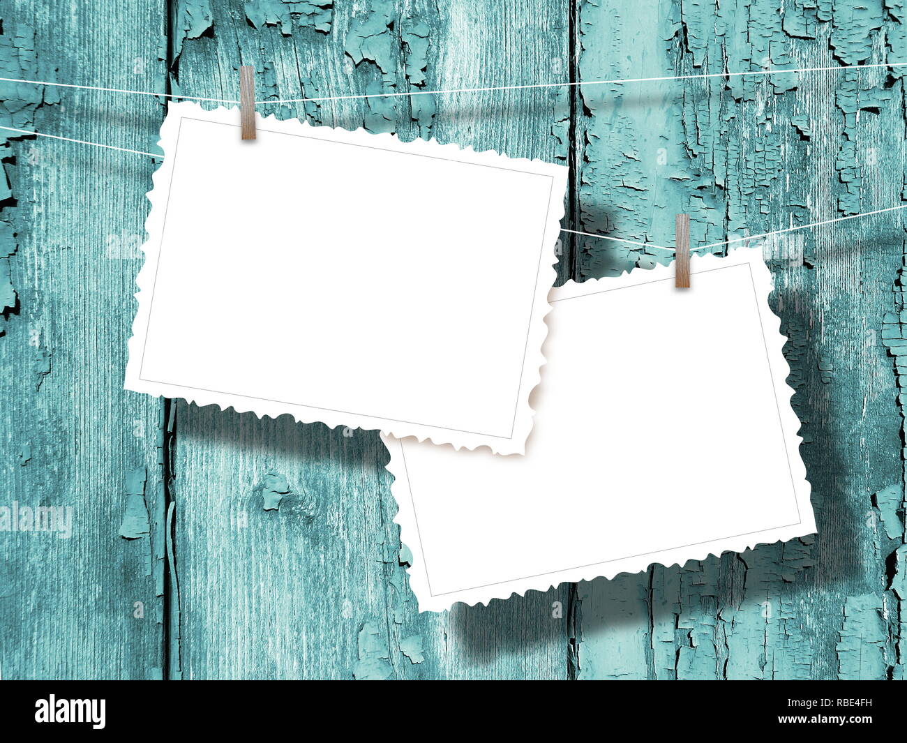 Two blank postcard frames against aqua weathered wooden background ...