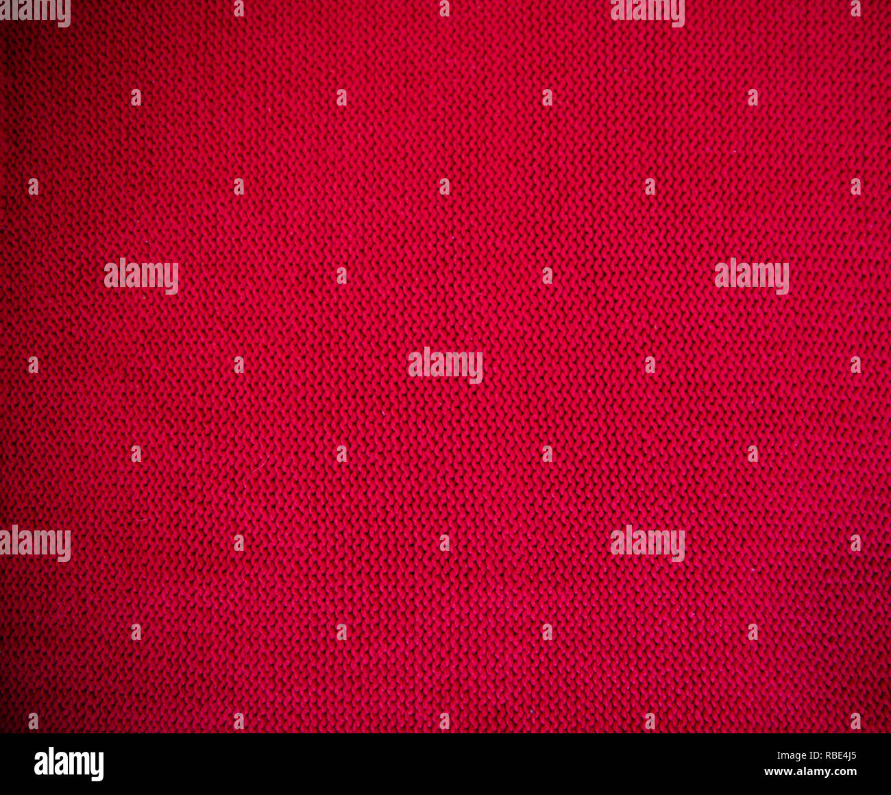 Red Knitted pattern wool sweater texture close up. Handmade red ...