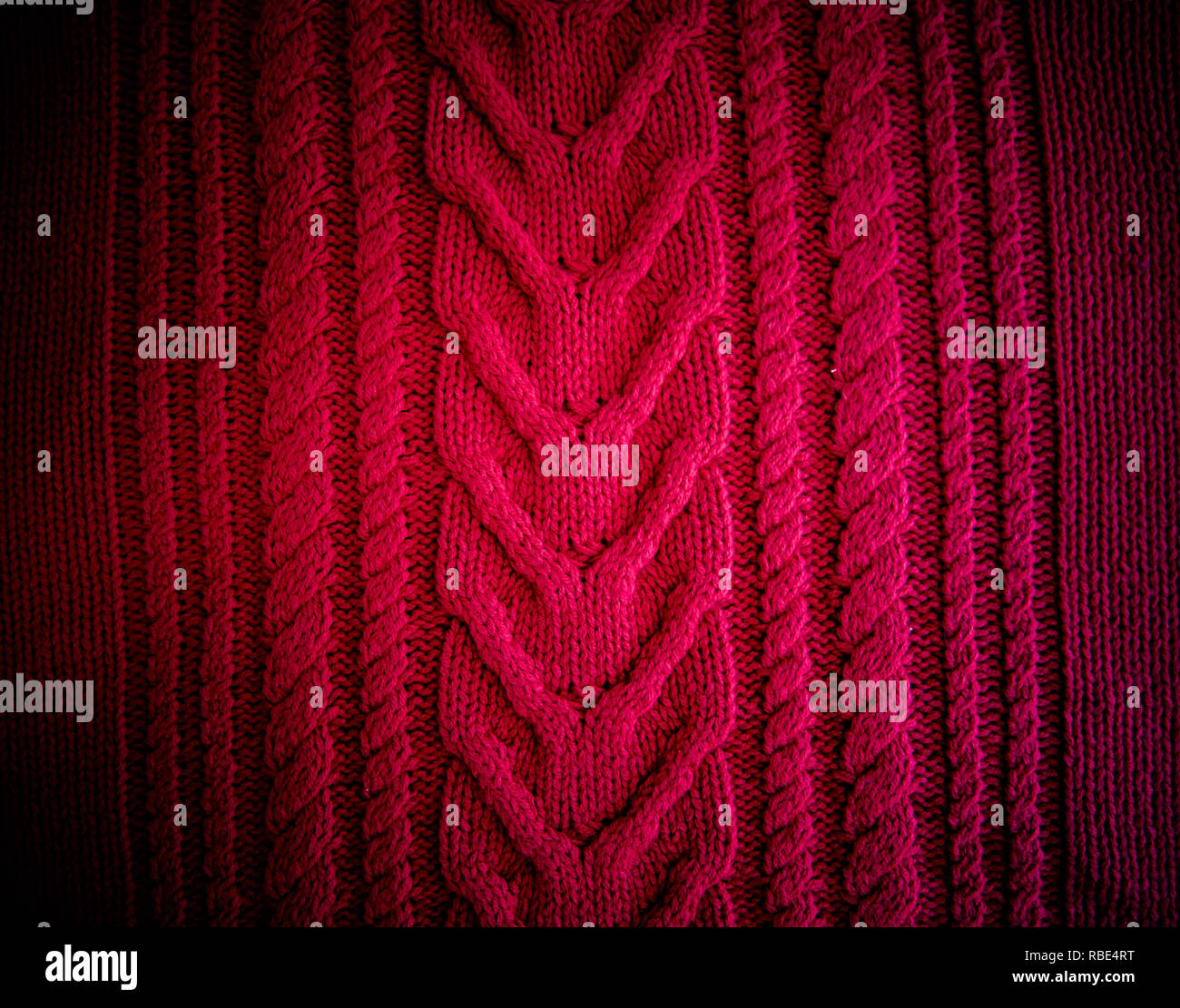 Red Knitted pattern wool sweater texture close up. Handmade red ...