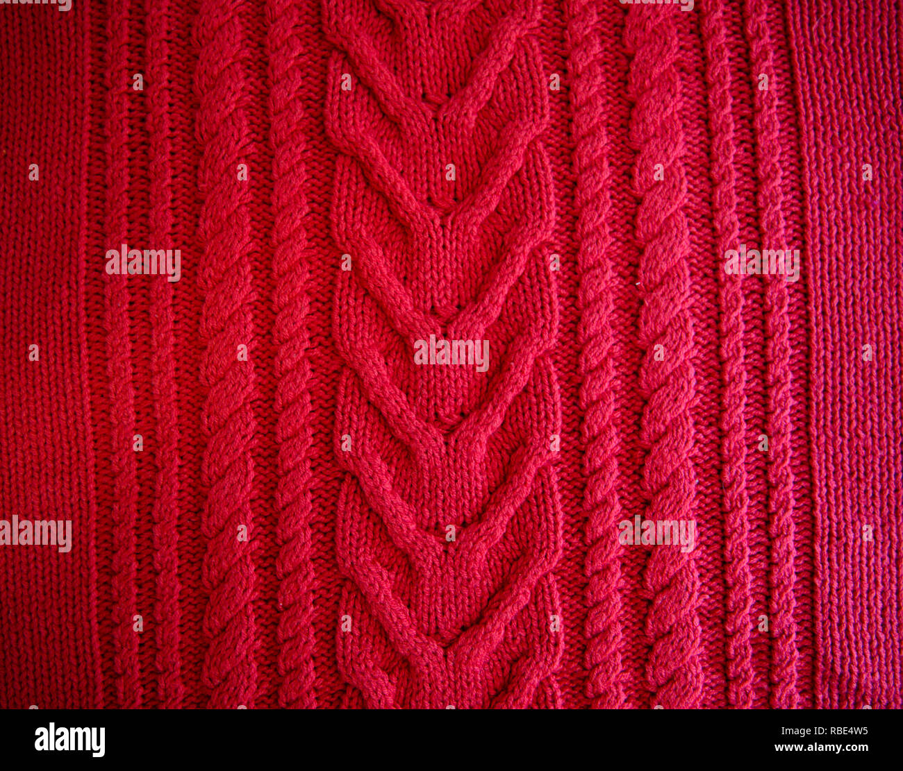 Red Knitted pattern wool sweater texture close up. Handmade red ...
