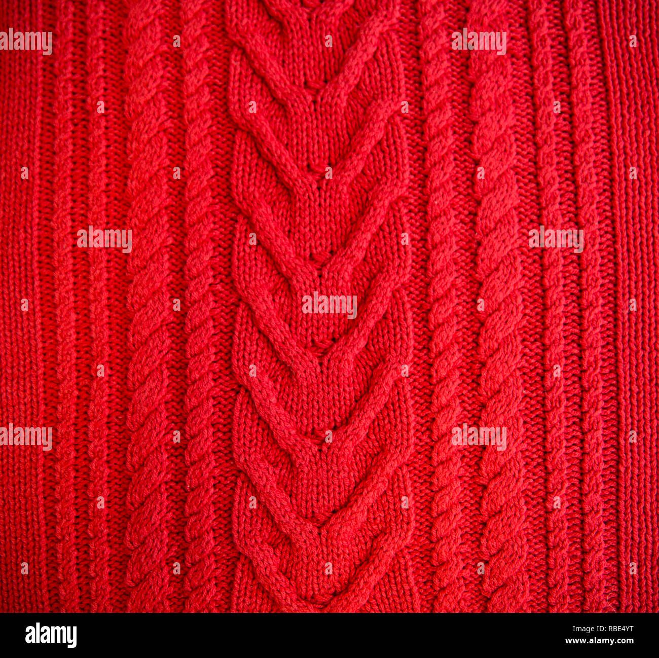 Red Knitted pattern wool sweater texture close up. Handmade red ...