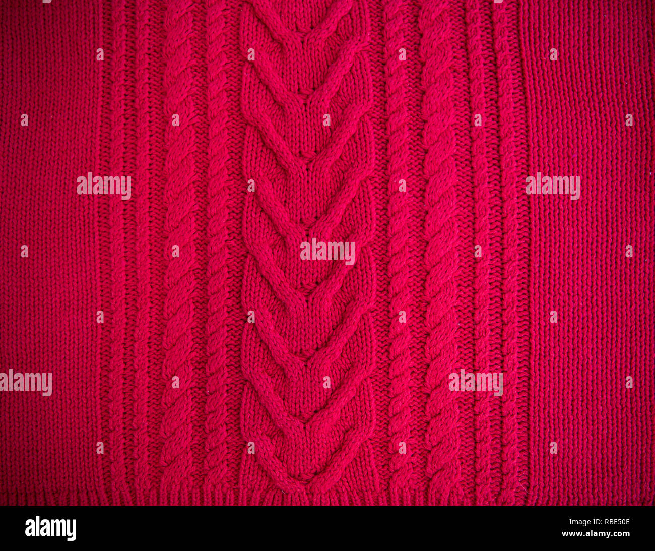 Red Knitted pattern wool sweater texture close up. Handmade red ...