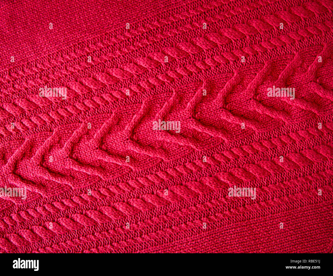 Red Knitted pattern wool sweater texture close up. Handmade red ...