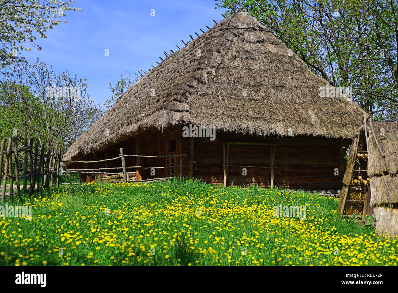 Peasants hut. Country house on spring landscape. Old village cottage ...