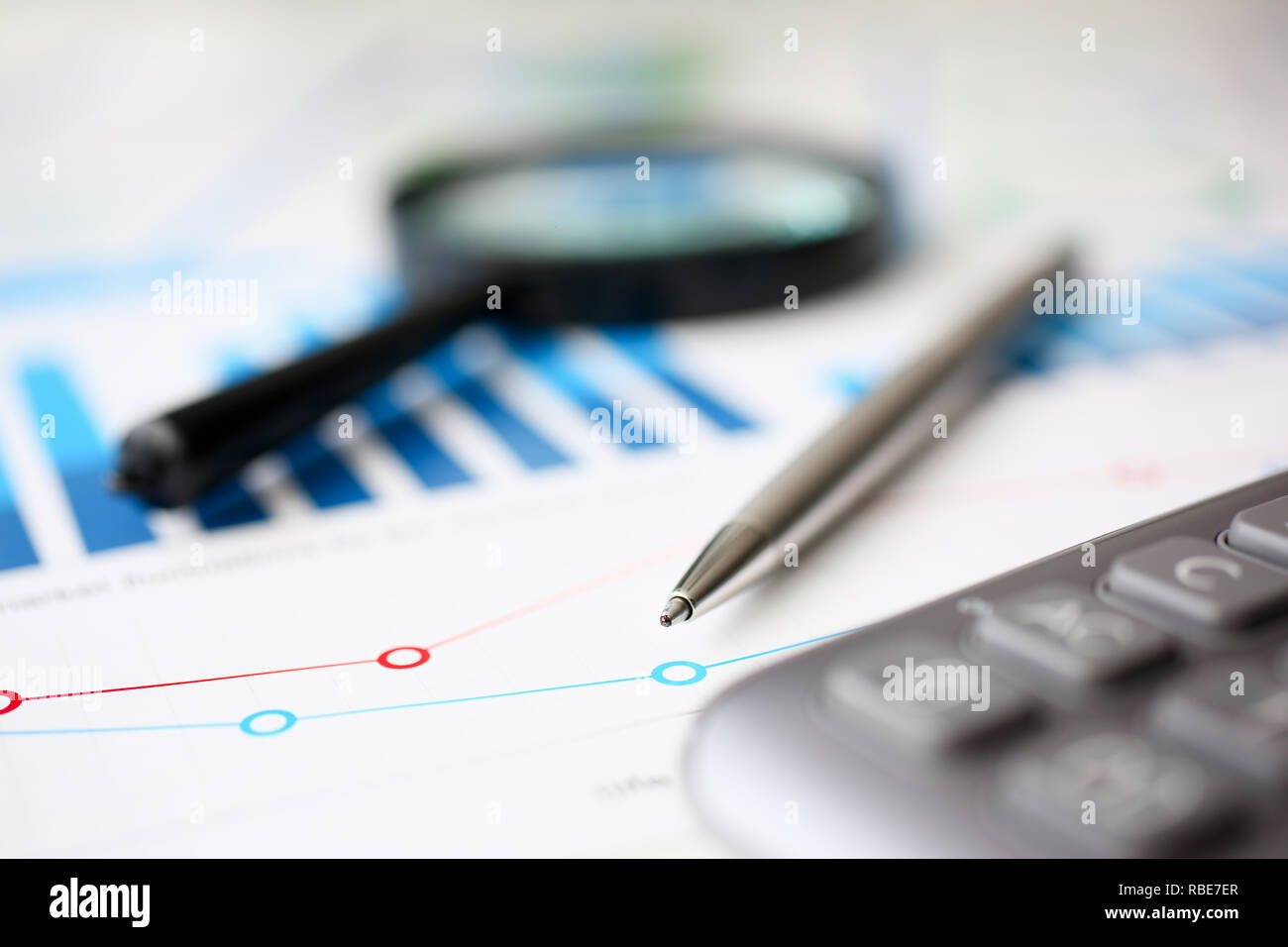 Financial statistics documents ball pen infographics Stock Photo - Alamy
