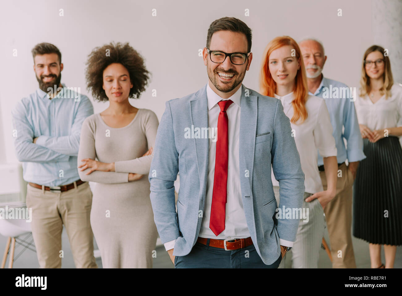 Line of happy and positive business people standing in the office Stock ...