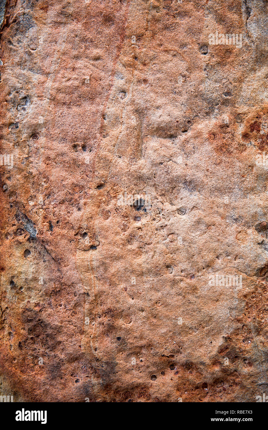 Closeup of the red rough stone wall Stock Photo - Alamy