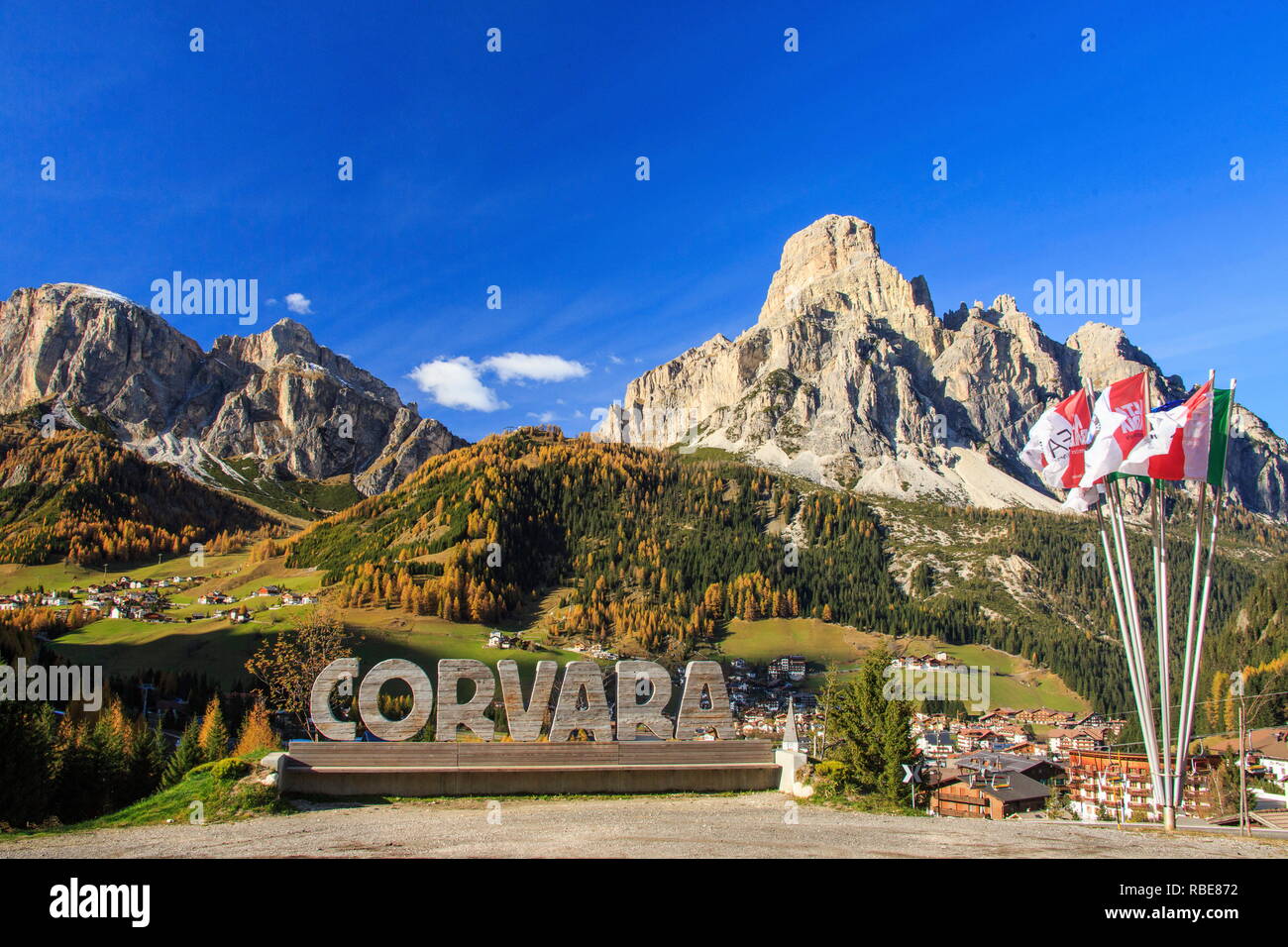 The colorful woods frame the village of Corvara and the high peaks ...