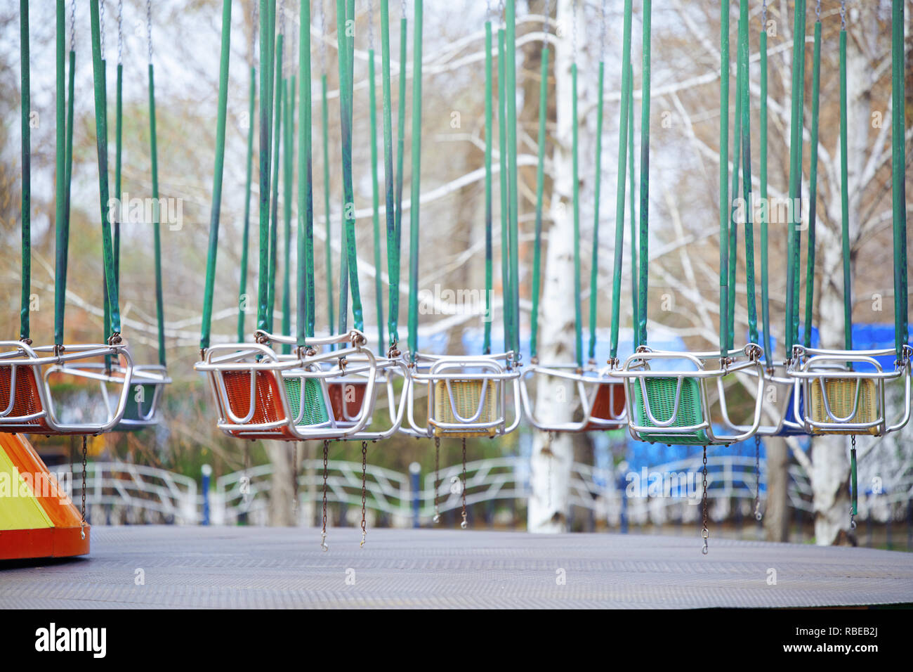 Empty chain swing in amuzement park Stock Photo - Alamy