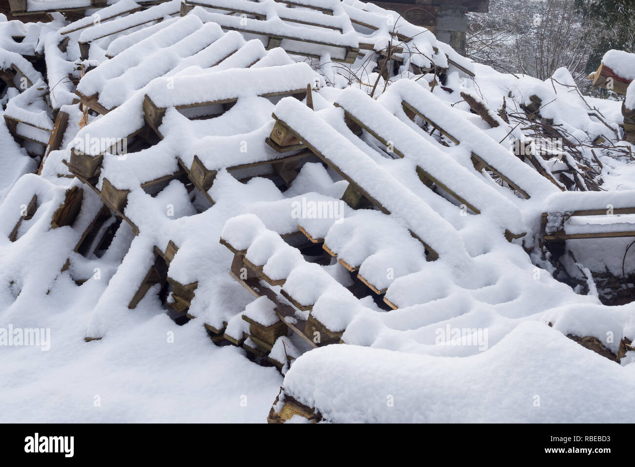 Wood and palets under the snow. Winterfield Stock Photo - Alamy