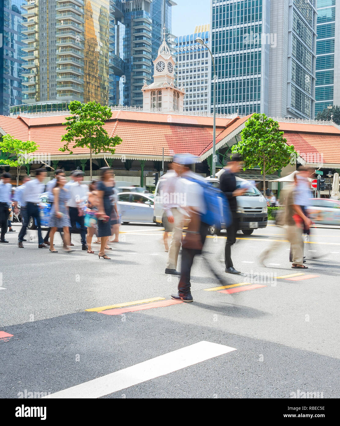 People walking by crossroad during rush hour in business center of ...