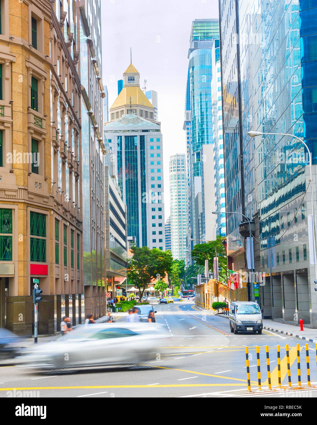 Traffic on street of Singapore business downtown district with office ...